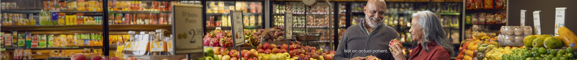 Elderly couple talking and grocery shopping together