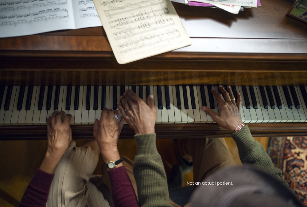 Hands of a couple playing the piano together